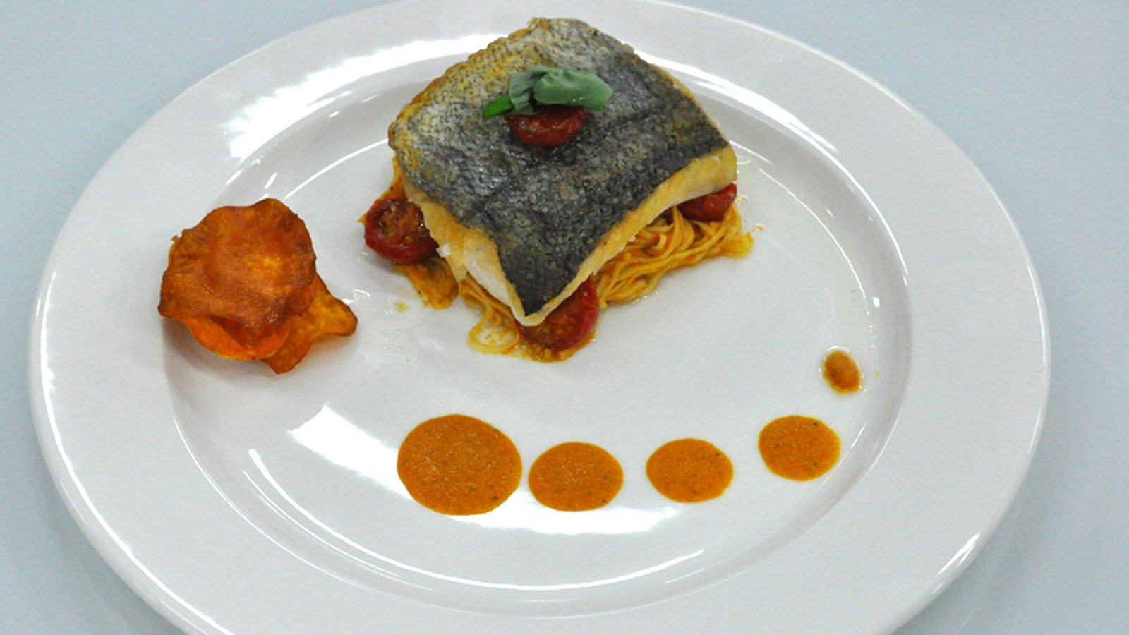 Hake and tomato pasta with sweet potato crisps