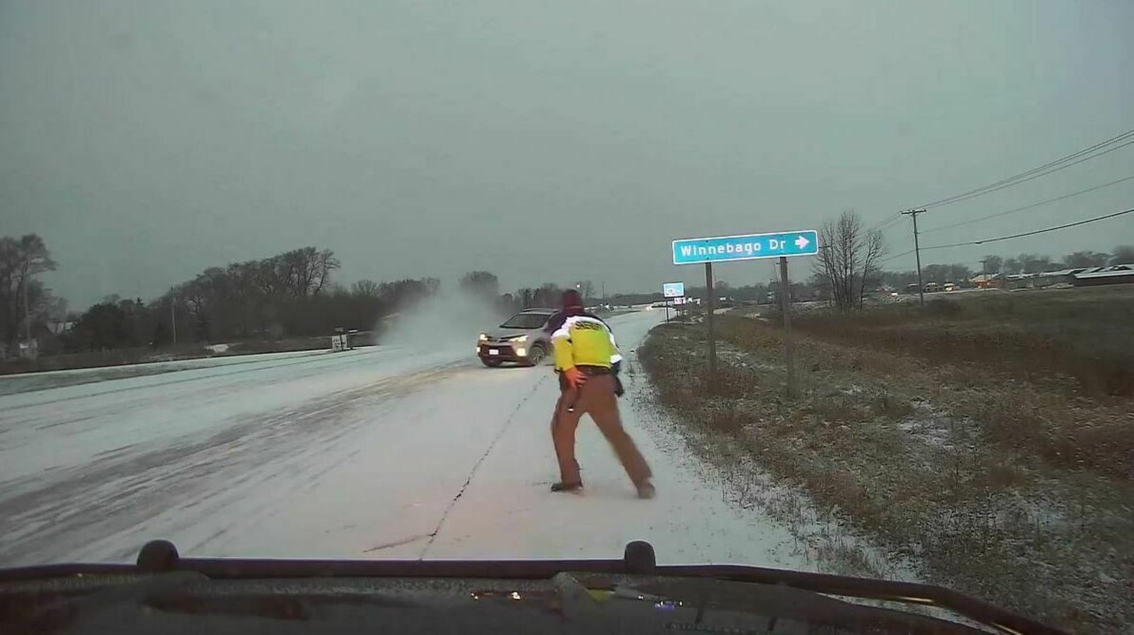 Close call: Sliding car narrowly misses US policeman