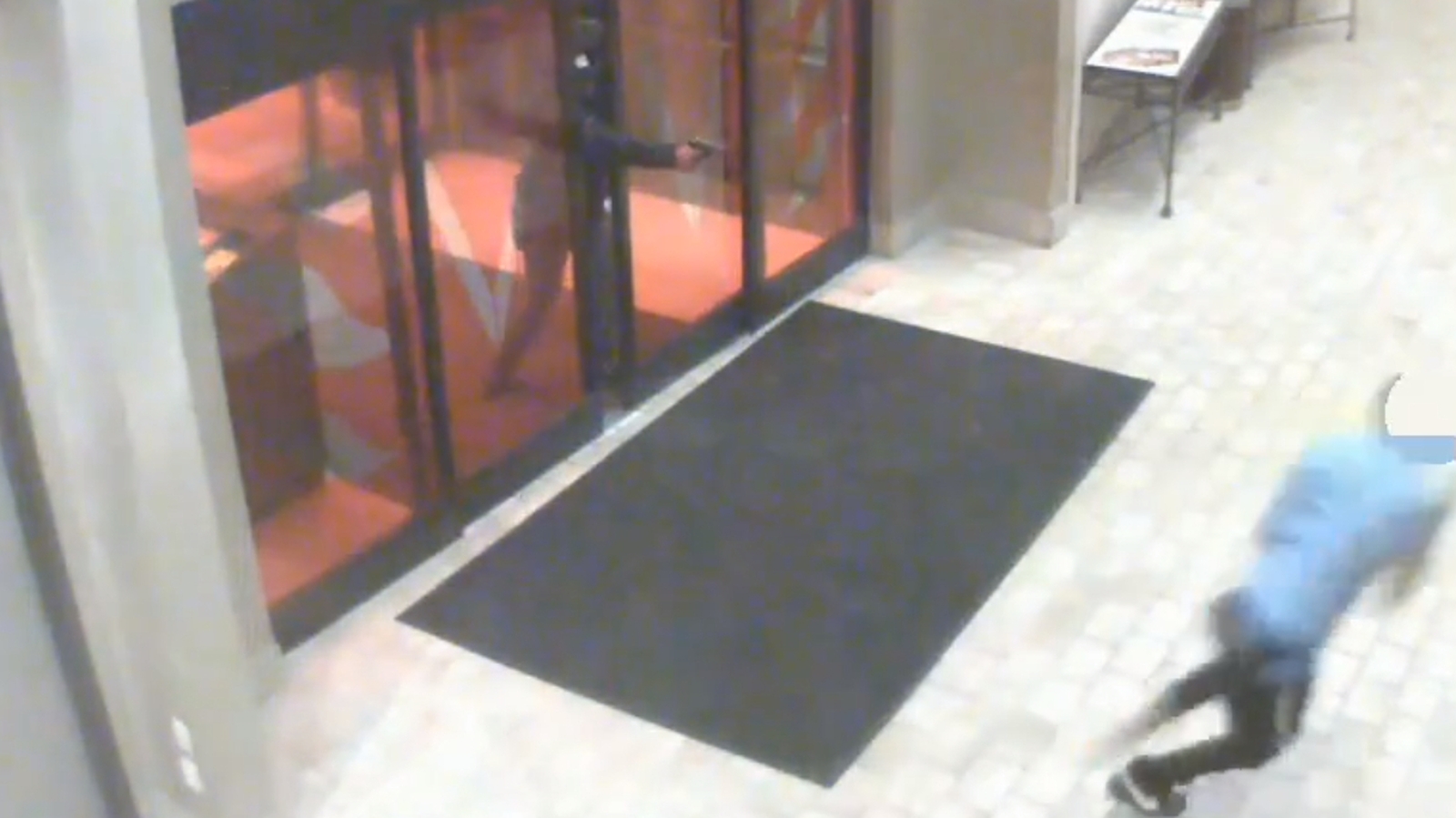 Man escapes shooter by forcing through hotel doors
