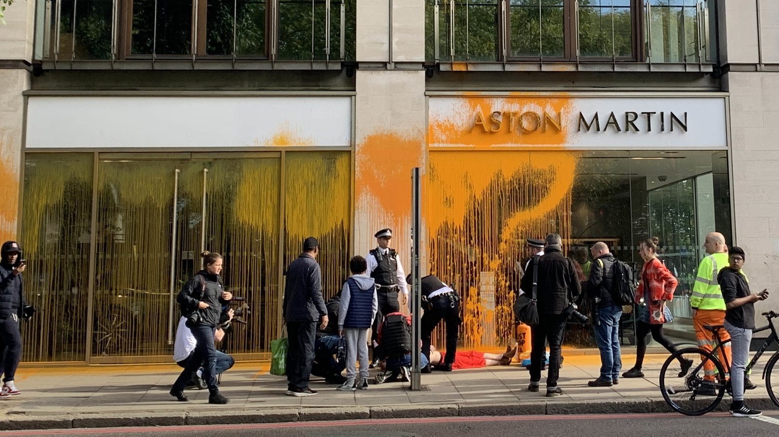Activists spray paint over Aston Martin showroom
