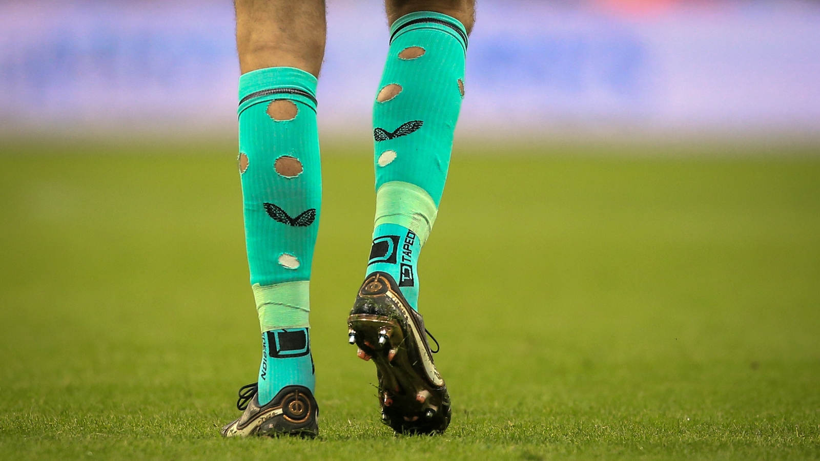 Why do some soccer players cut holes in their socks?